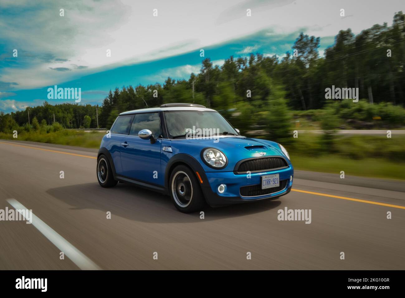 A blue mini cooper on road during drive Stock Photo - Alamy