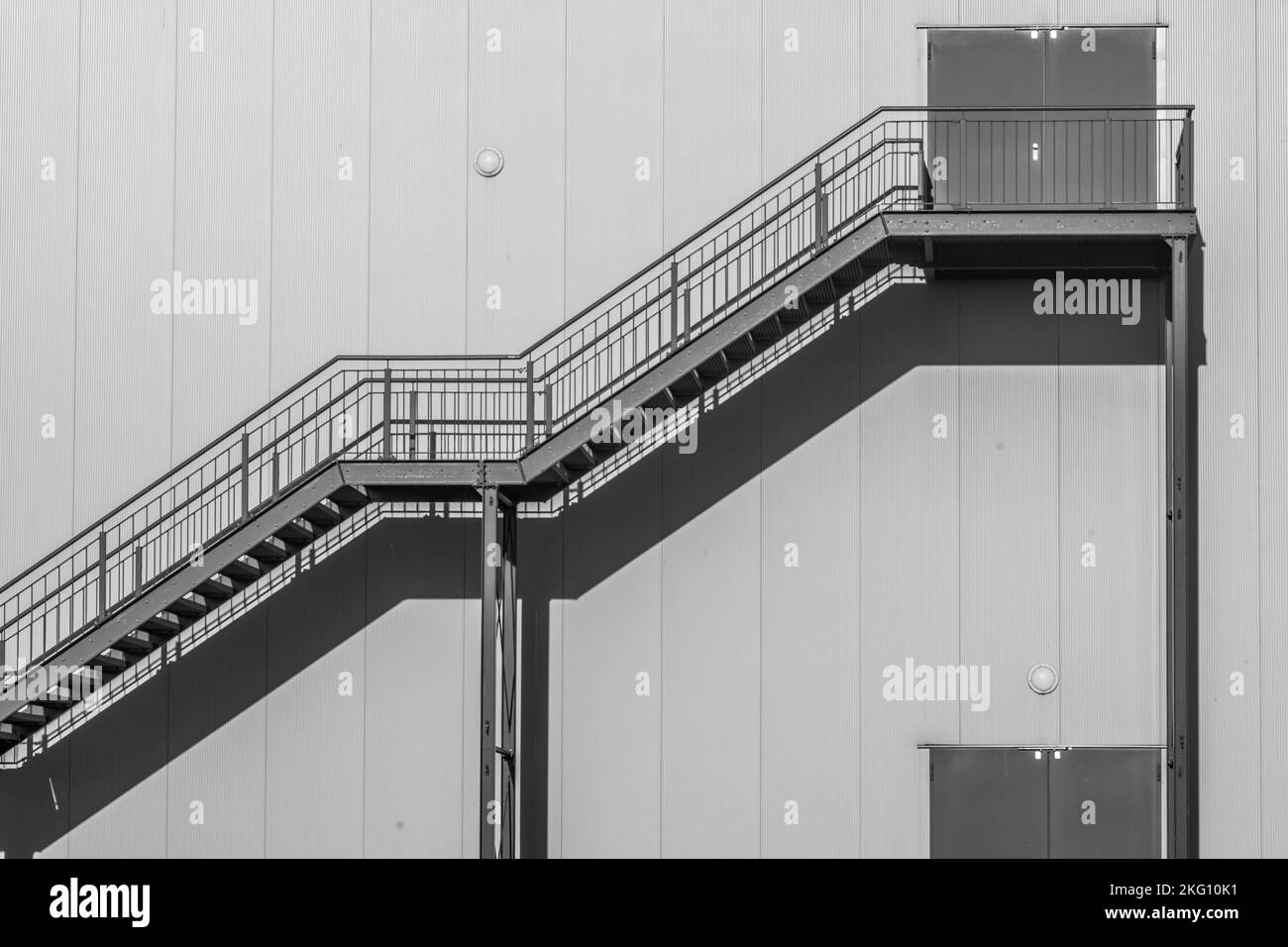 A grayscale shot of an external fire escape on the wall of a building ...