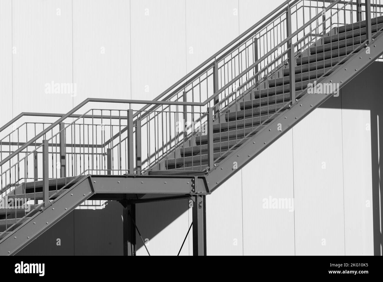 A grayscale shot of an external fire escape on the wall of a building ...