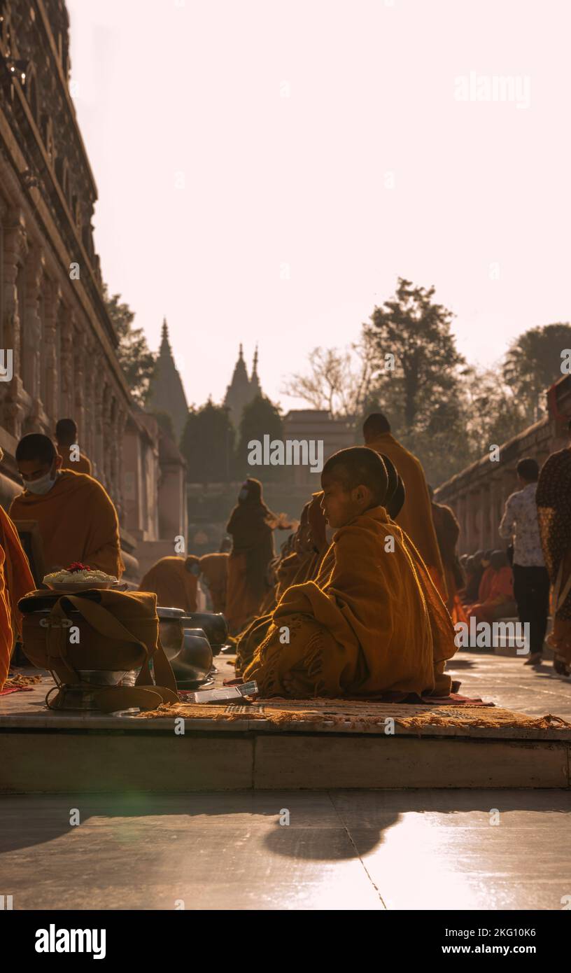 A vertical shot of the young Buddhist monks praying at Mahabodhi Temple ...