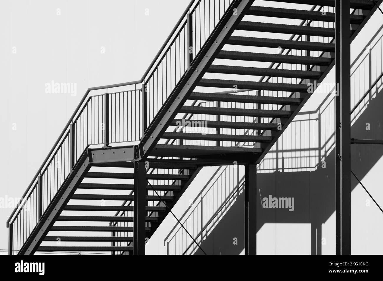 A grayscale shot of an external fire escape on the wall of a building ...