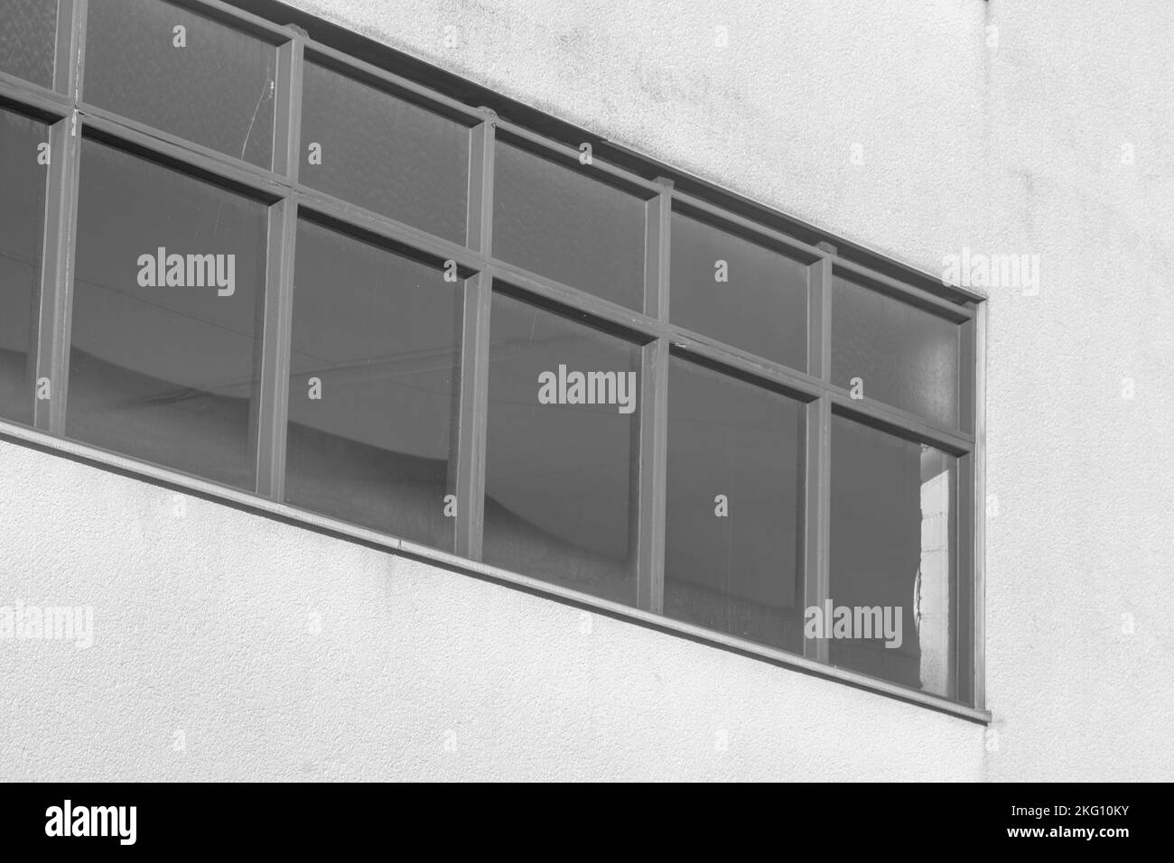 A grayscale shot of the windows of a building Stock Photo - Alamy
