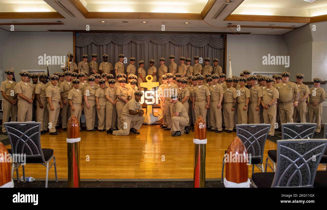 Chief petty officers pose for a photo during a chief petty officer ...