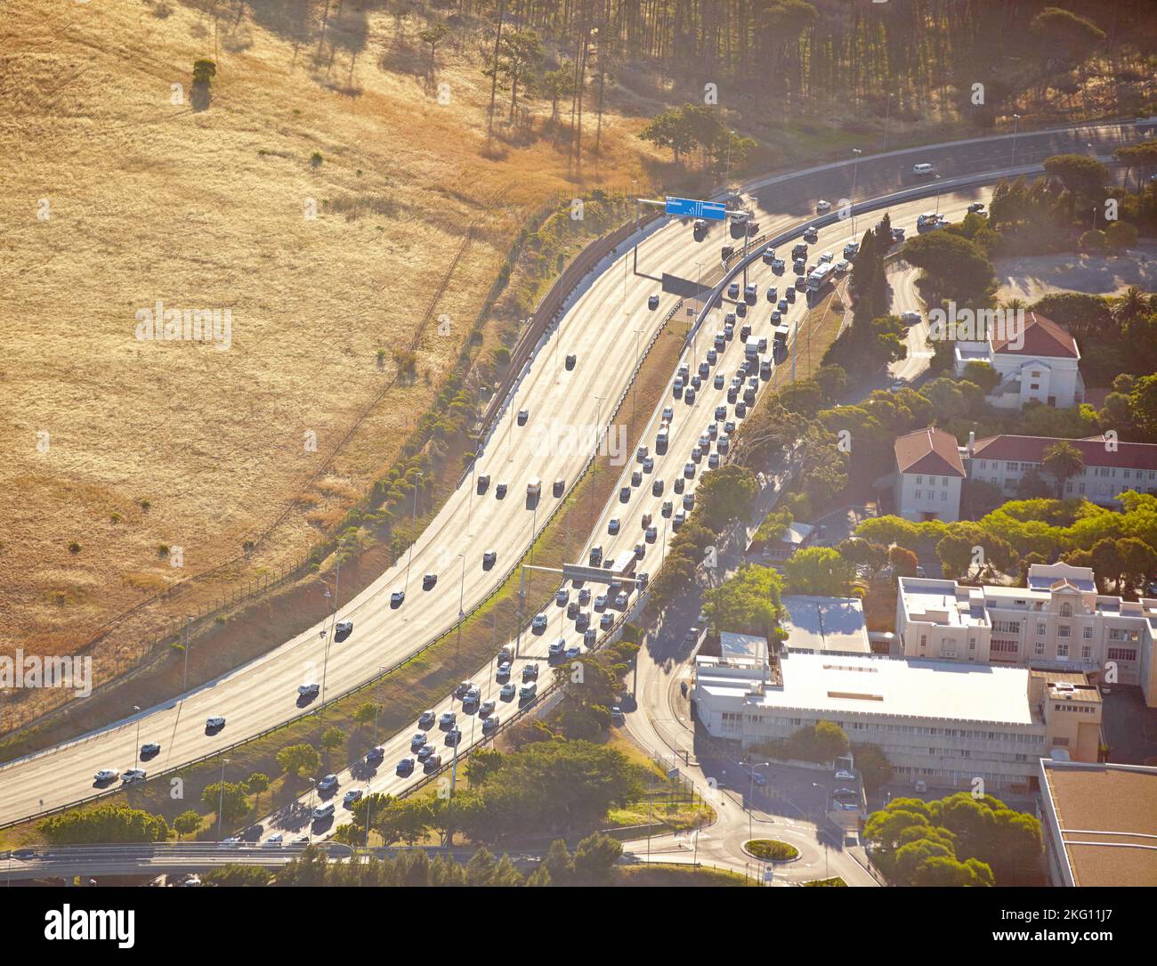 Urban development and green space. Aerial view of a highway running ...