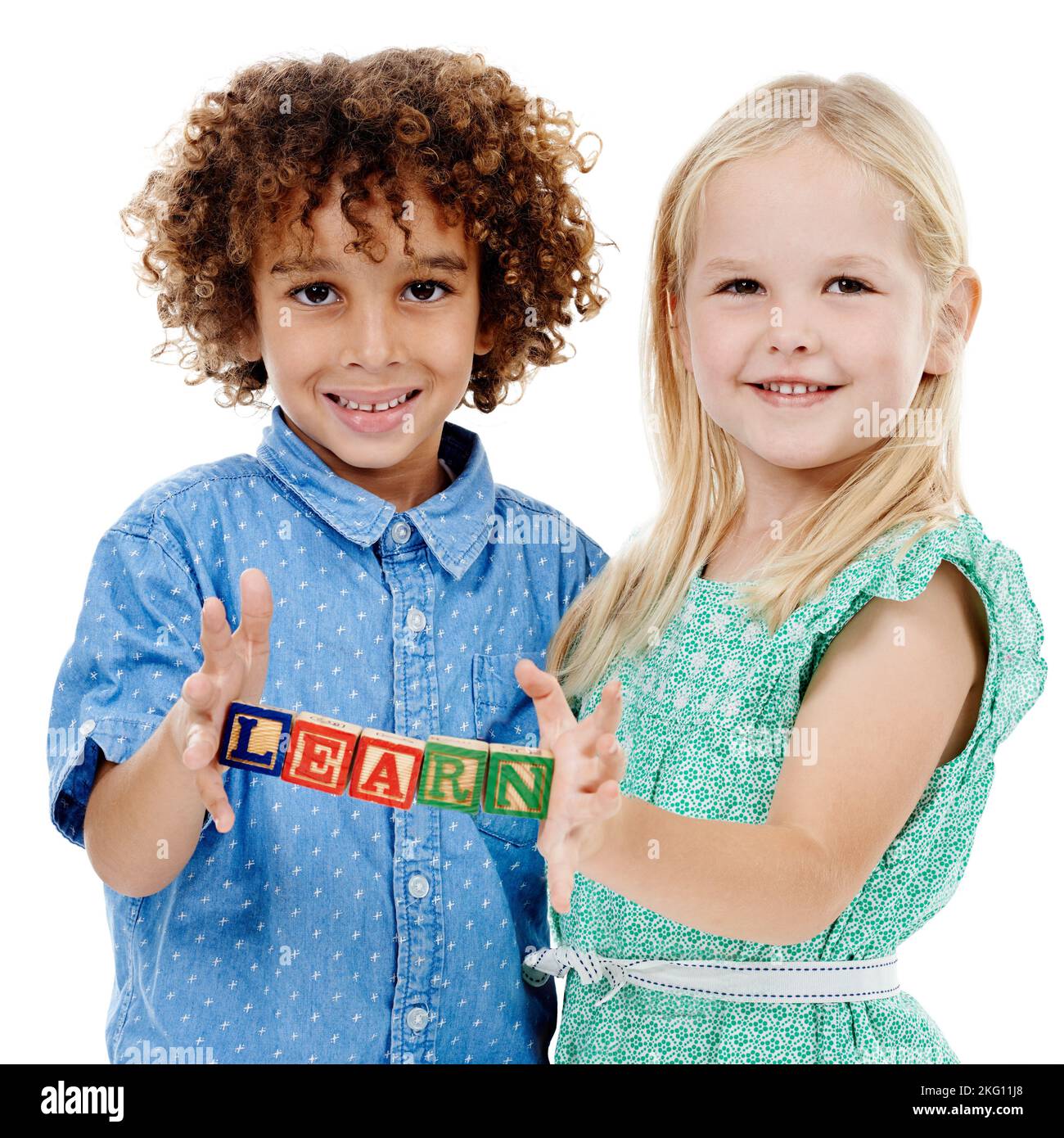 Molding little minds. Studio shot of a cute little boy and girl holding ...