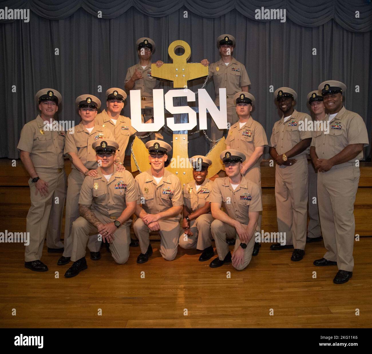 Sailors pose for a photo following a chief petty officer pinning ...