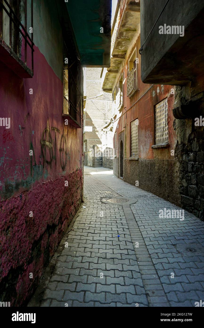 A vertical shot of a narrow street between aged buildings Stock Photo ...