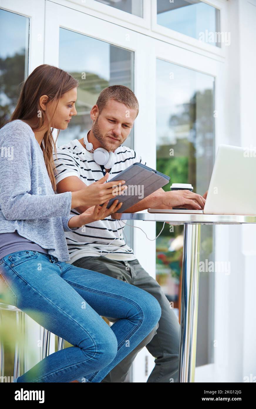Getting his opinion on the arrangements. a happy young couple working ...