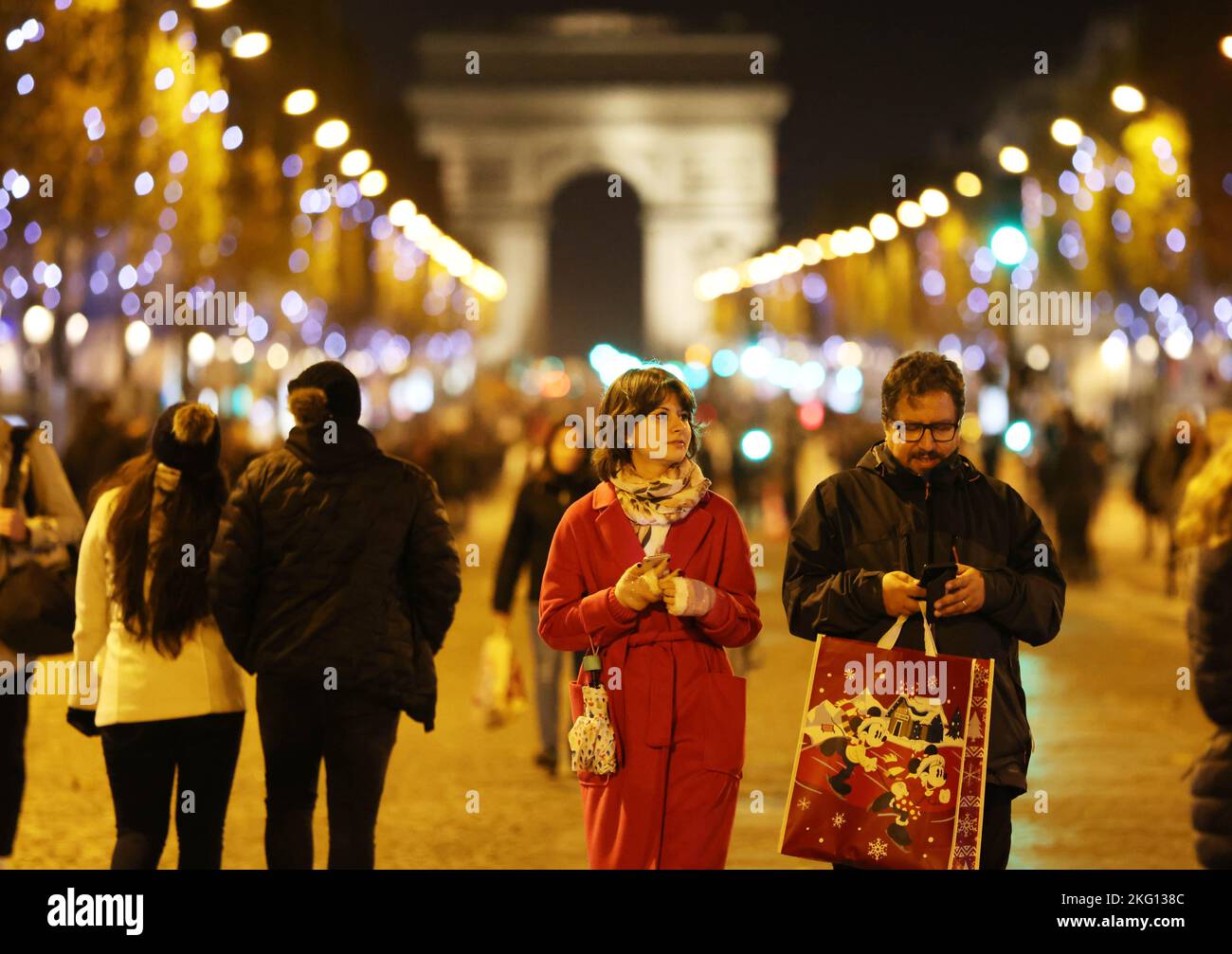Paris, France. 20th Nov, 2022. People walk at the Champs-Elysees lit by ...