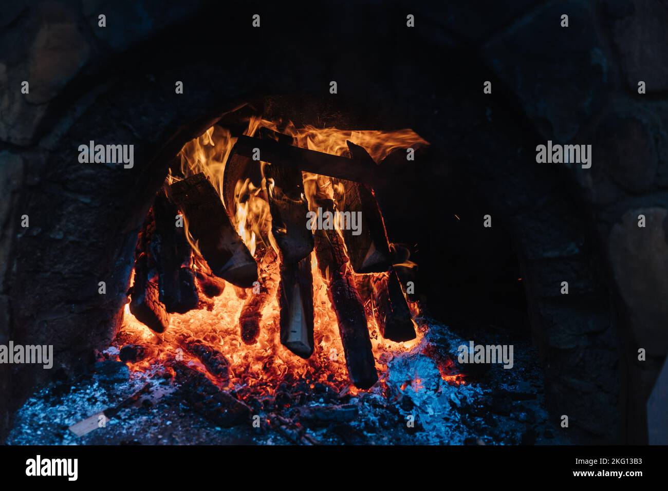 Beautiful bonfire under steaming cast iron hot tub with spa in winter ...
