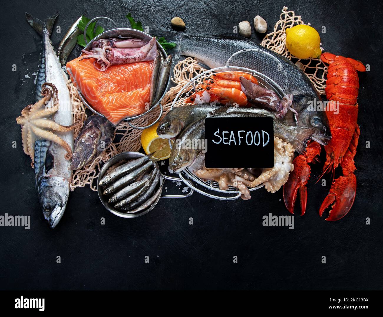 Fresh fish and seafood assortment on black background, fish market ...