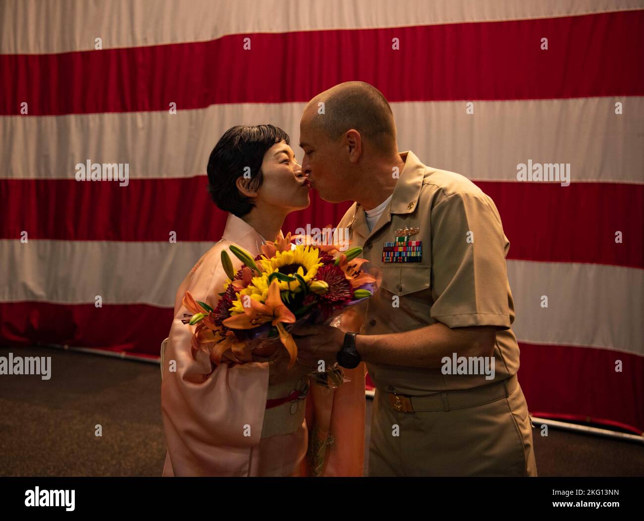 Chief Musician Alan Holland kisses his wife during a chief petty ...