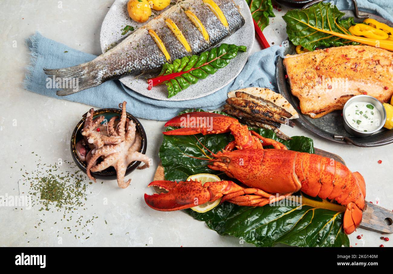 Seafood platter. Assorted delicious seafood with vegetables on a grey ...