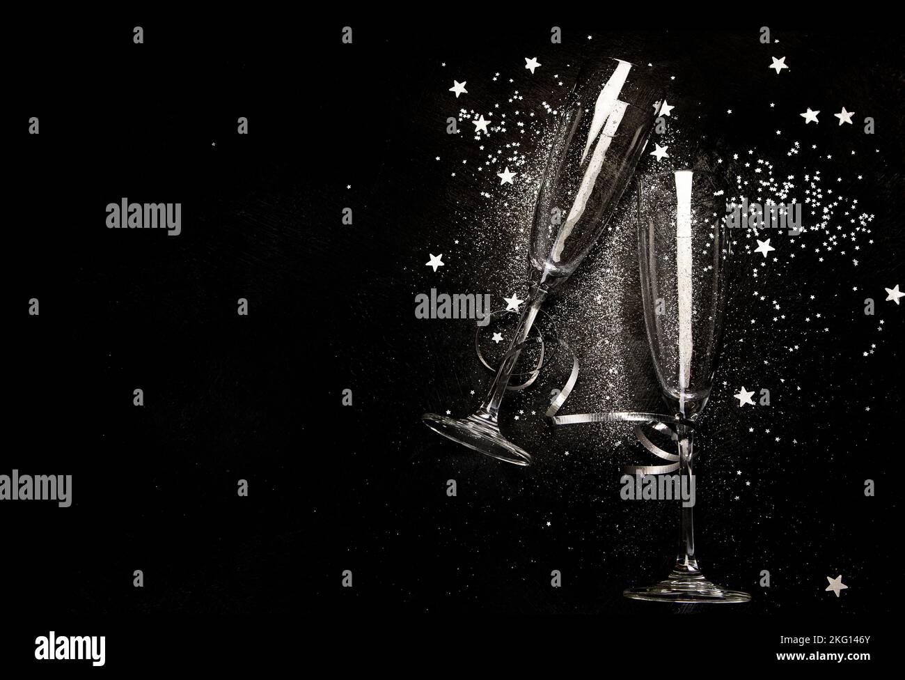 Two champagne glasses. Christmas decoration on a black background ...