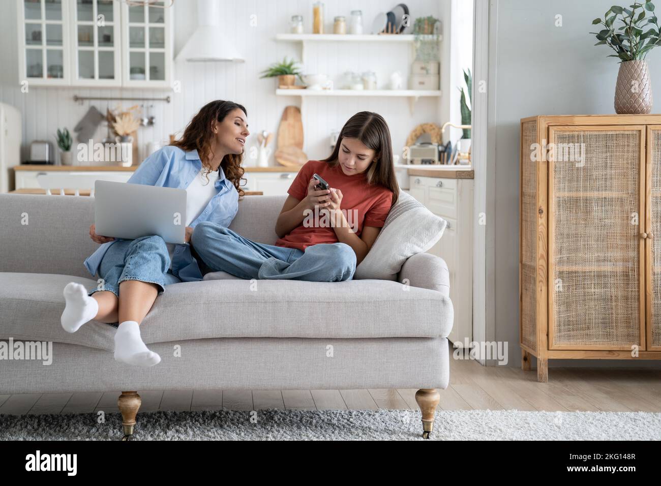 Independent everyday teen girl sits on sofa keeps secrets from mom ...