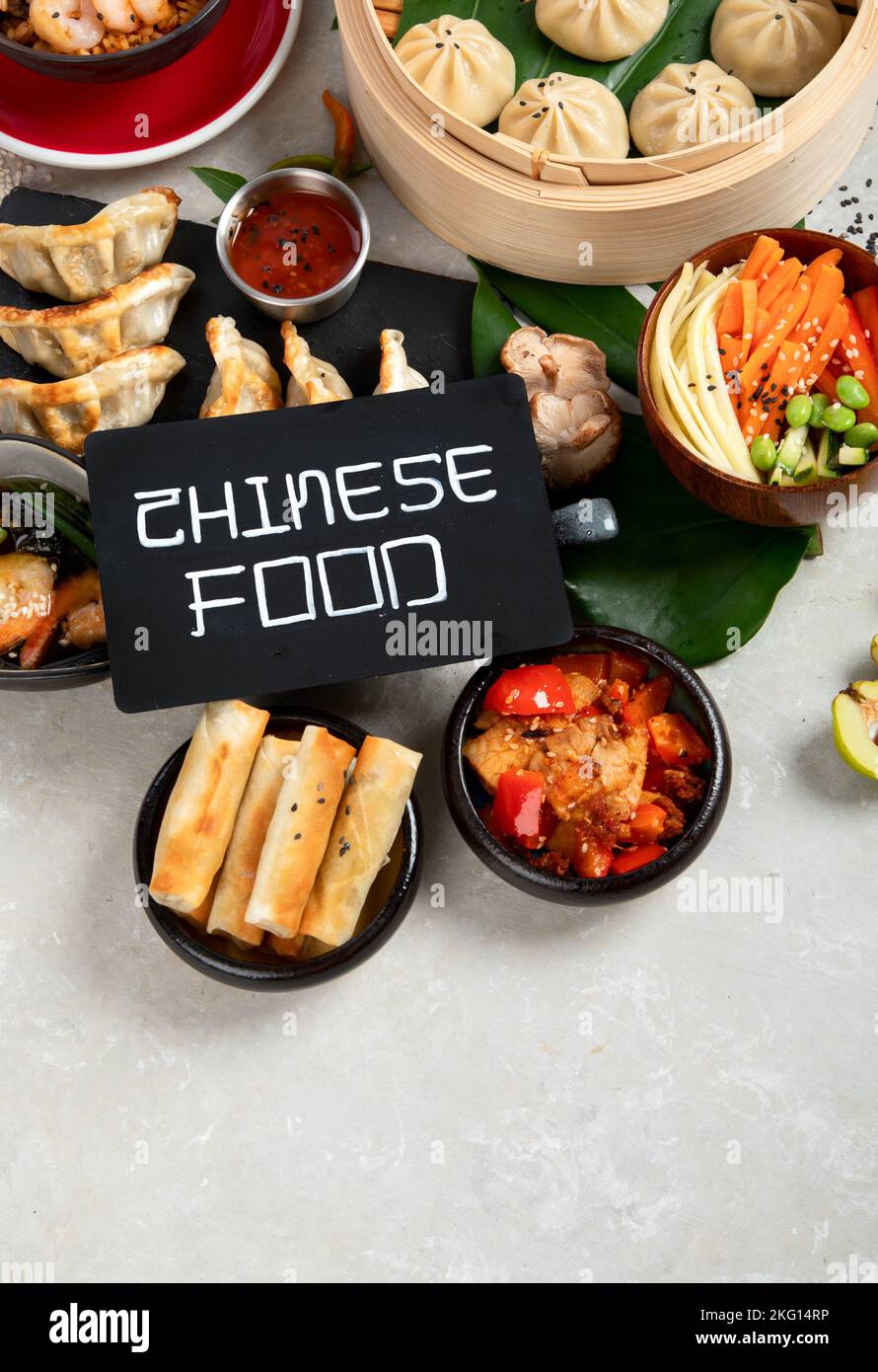 Assorted Chinese food on dark background. Chinese cuisine dishes on ...