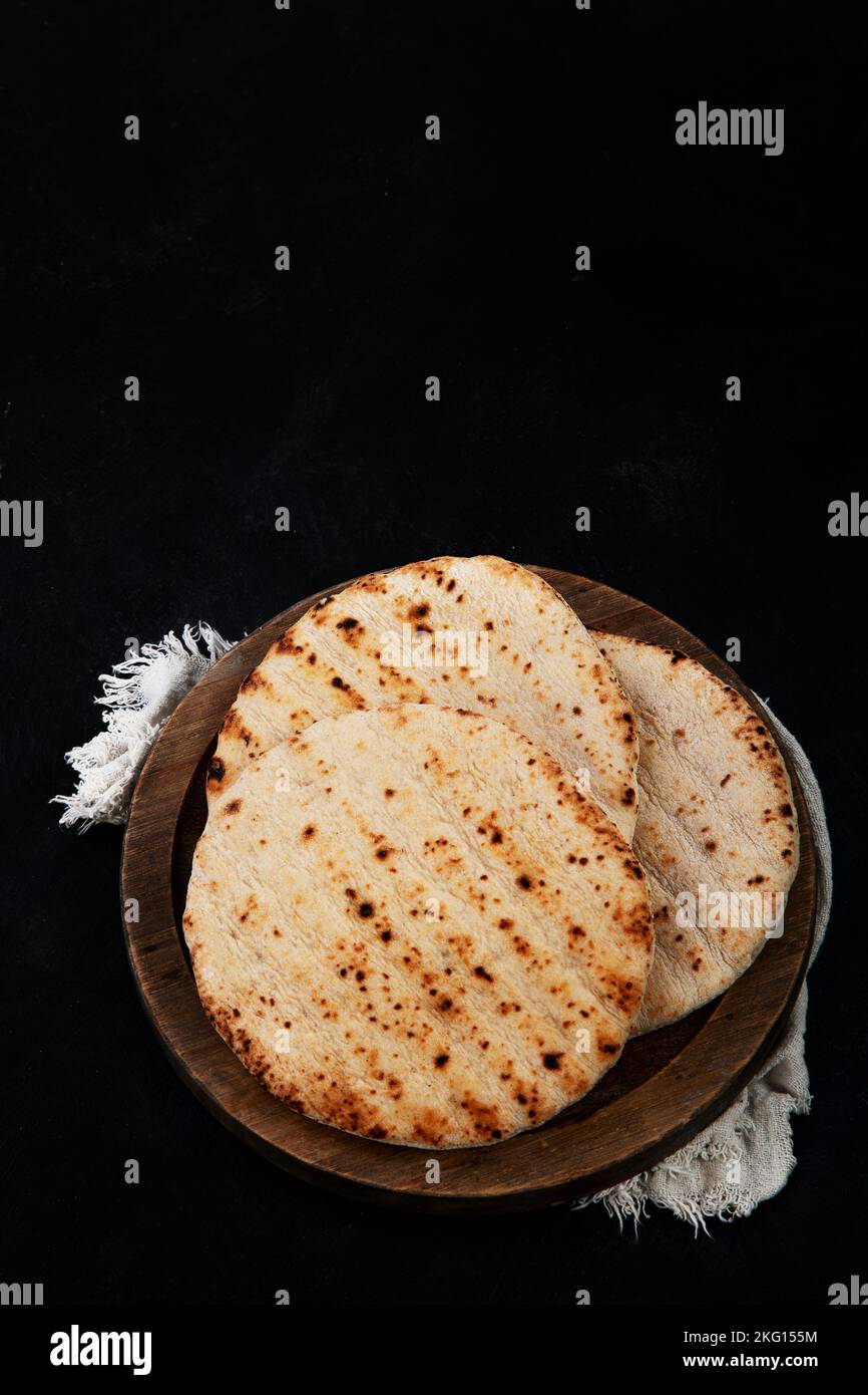 Pita bread isolated on a dark background. Traditional and typical food ...