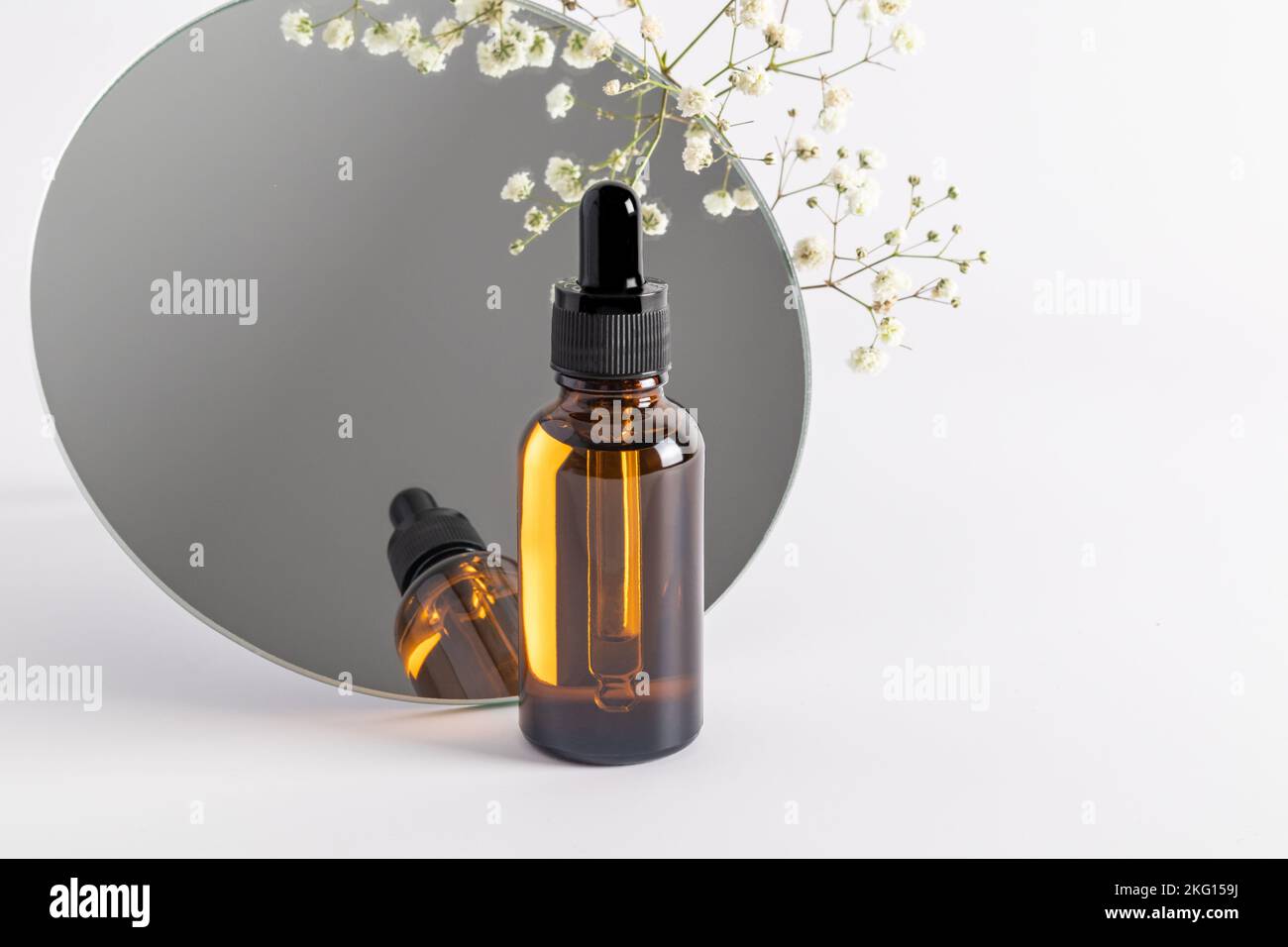 amber cosmetic bottle with a pipette on the background of a round ...