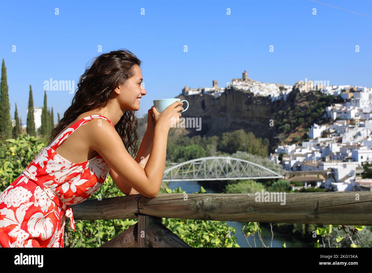 Profile of a tourist drinking coffee sightseeing in a town outskirts ...