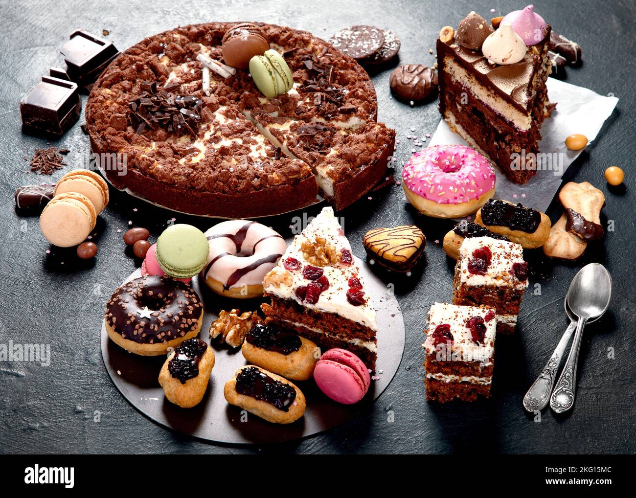 Assortment of confectionery, different types desserts on dark table ...