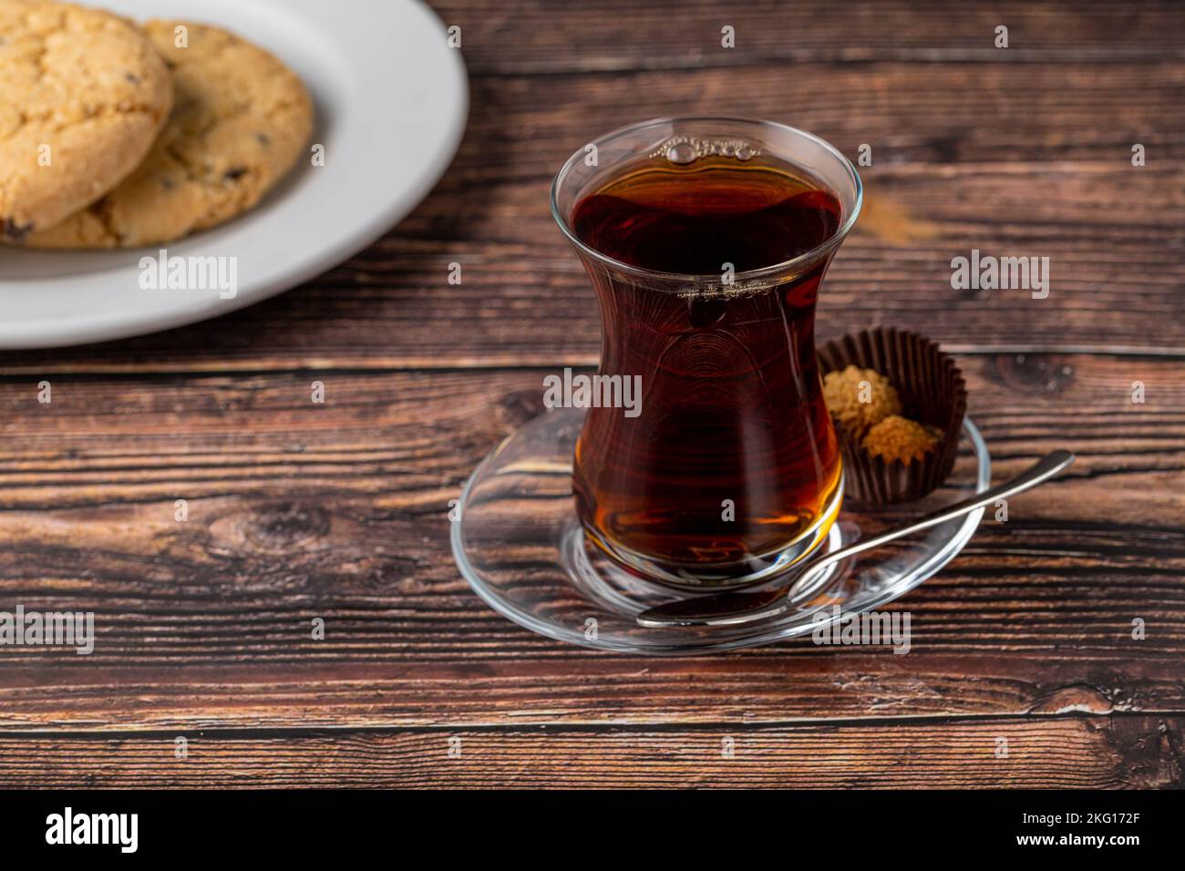 Freshly brewed black Turkish tea with cookies on wooden table Stock ...