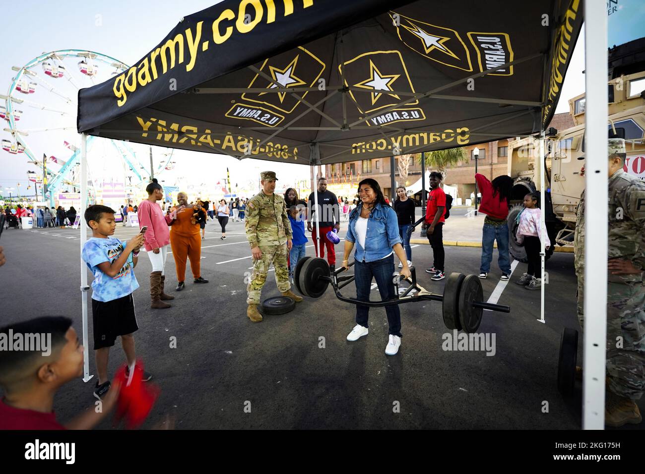 The crowd looks on as a fair goer tests their strength at the South ...