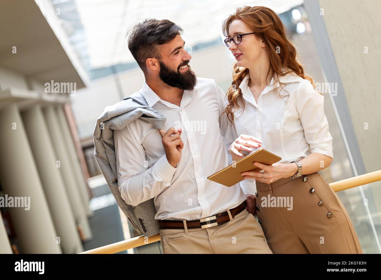 Business people having fun, teamwork and chatting at workplace office ...