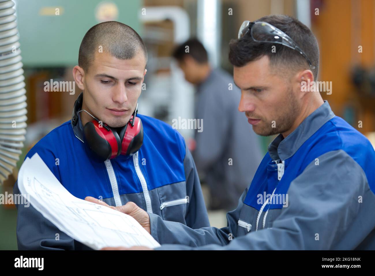 engineers working with building plan Stock Photo - Alamy