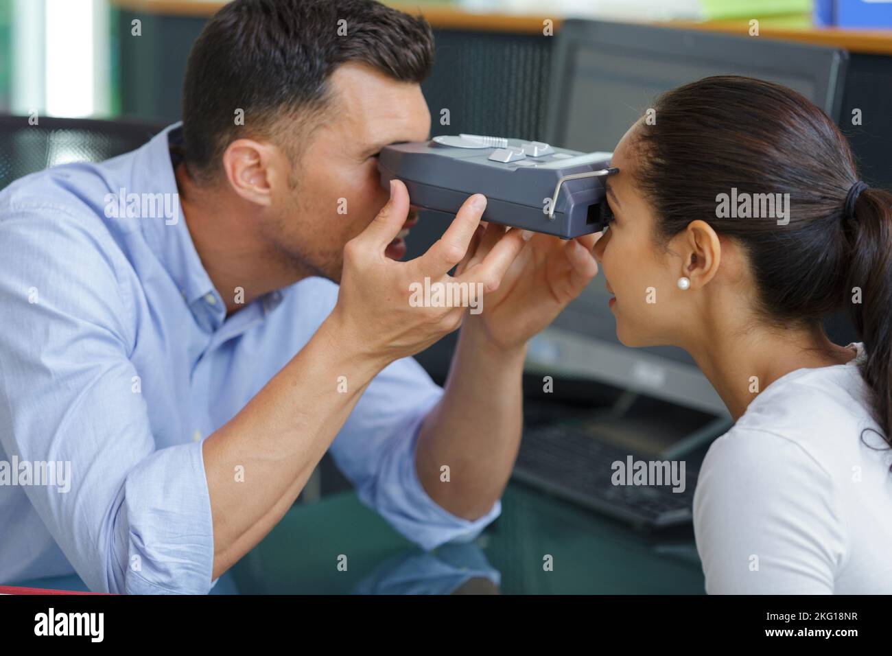 eye doctor is measuring a patients visual field Stock Photo - Alamy
