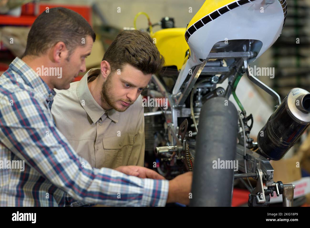 two worker in factory fixing a machine Stock Photo - Alamy