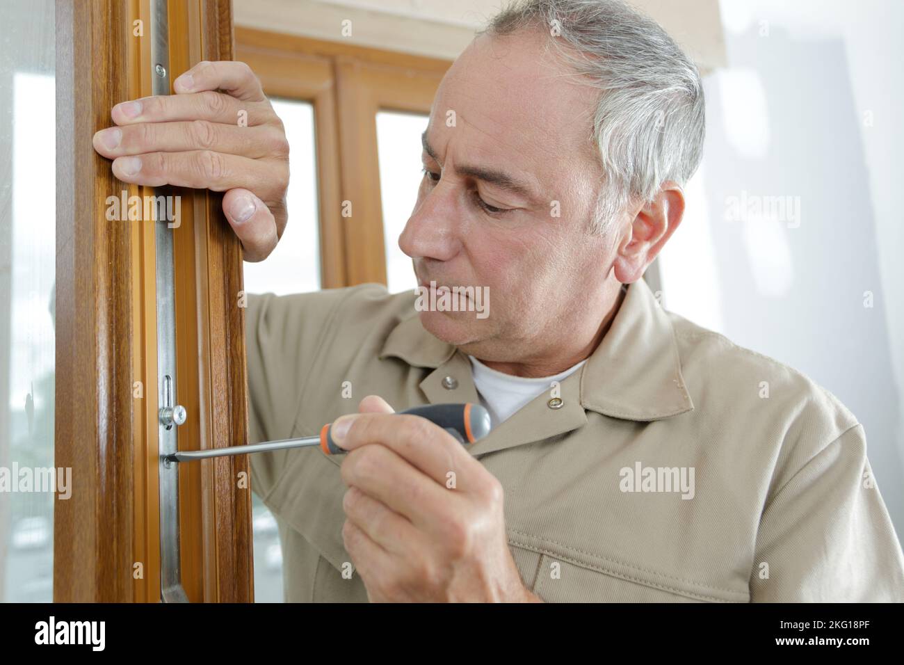 man in the 50s fixing a door Stock Photo - Alamy