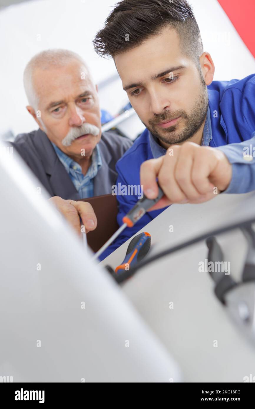 Apprentice working on machine hi-res stock photography and images - Alamy