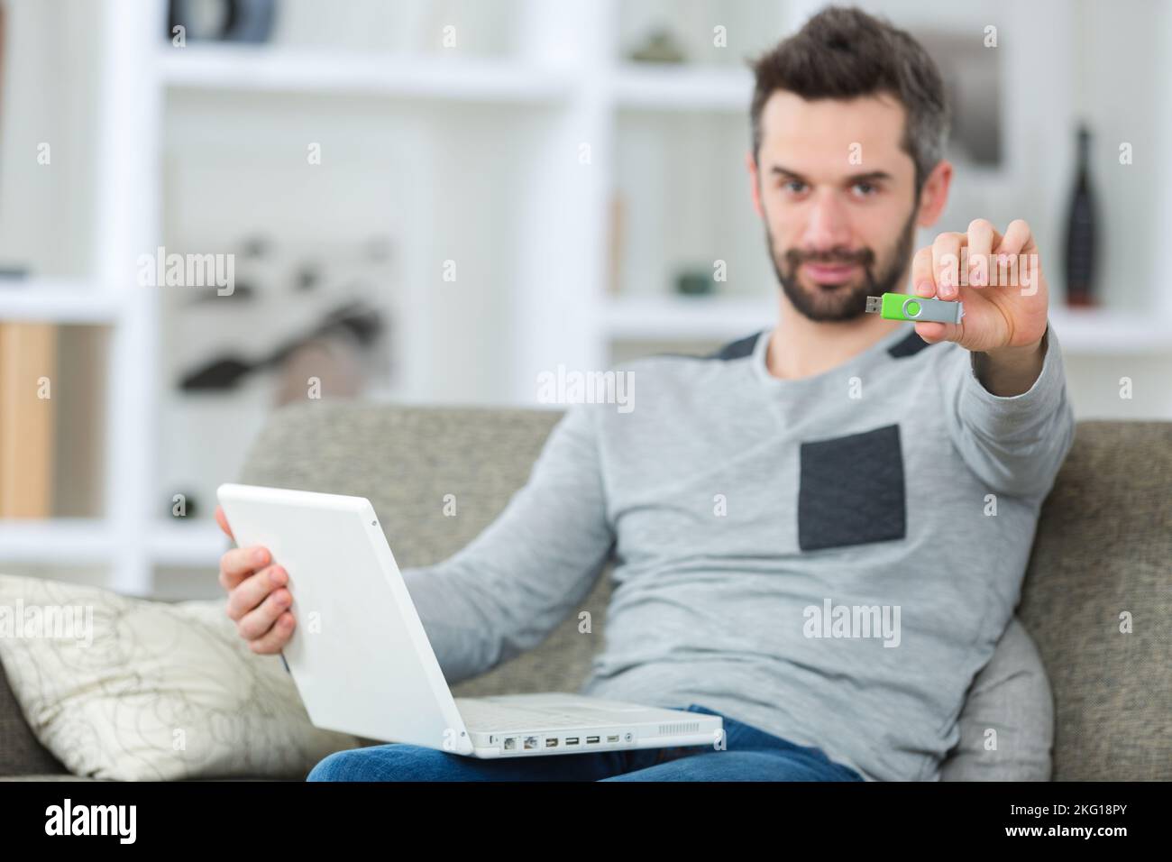 portrait of man showing usb Stock Photo - Alamy