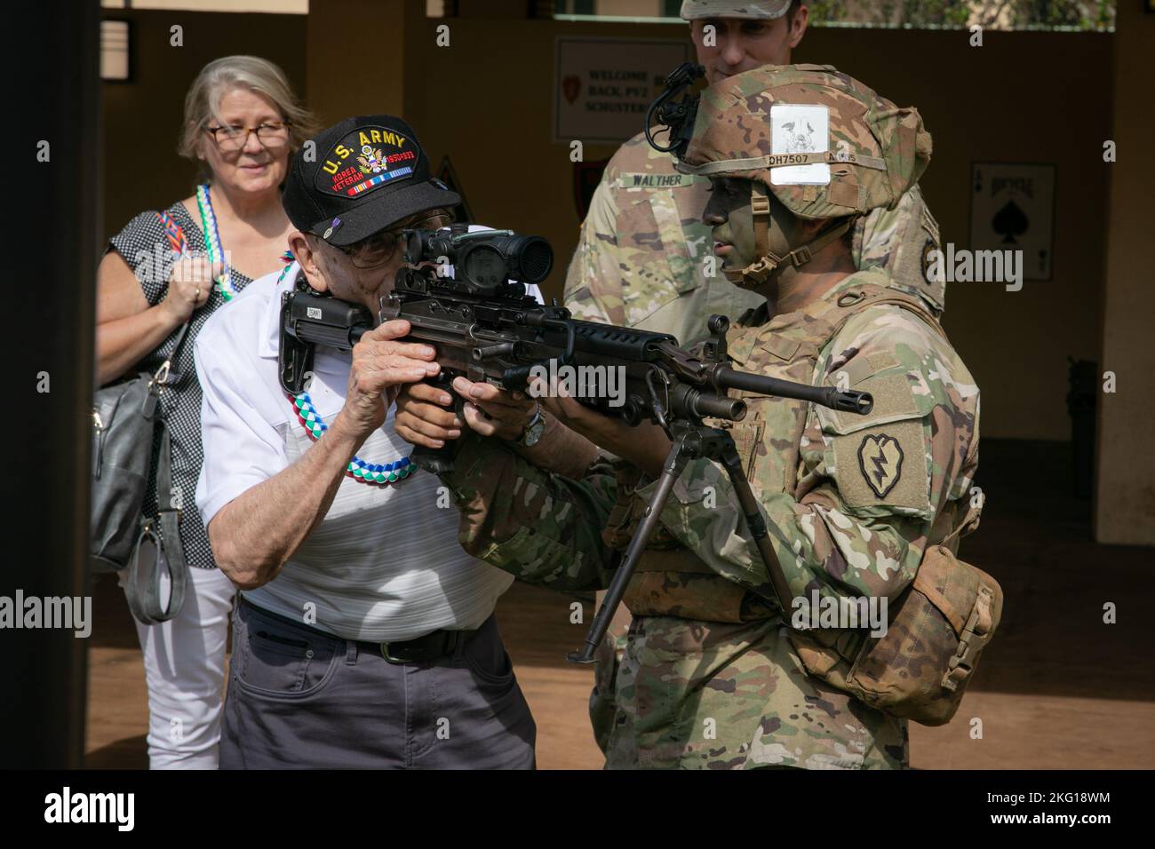 Private 2nd Class (ret.) Warren H. Schuster holds a M249 Light Machine ...