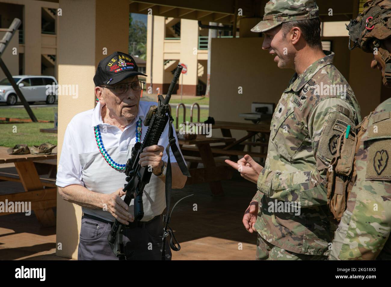 Private 2nd Class (ret.) Warren H. Schuster holds and observes an M4 ...