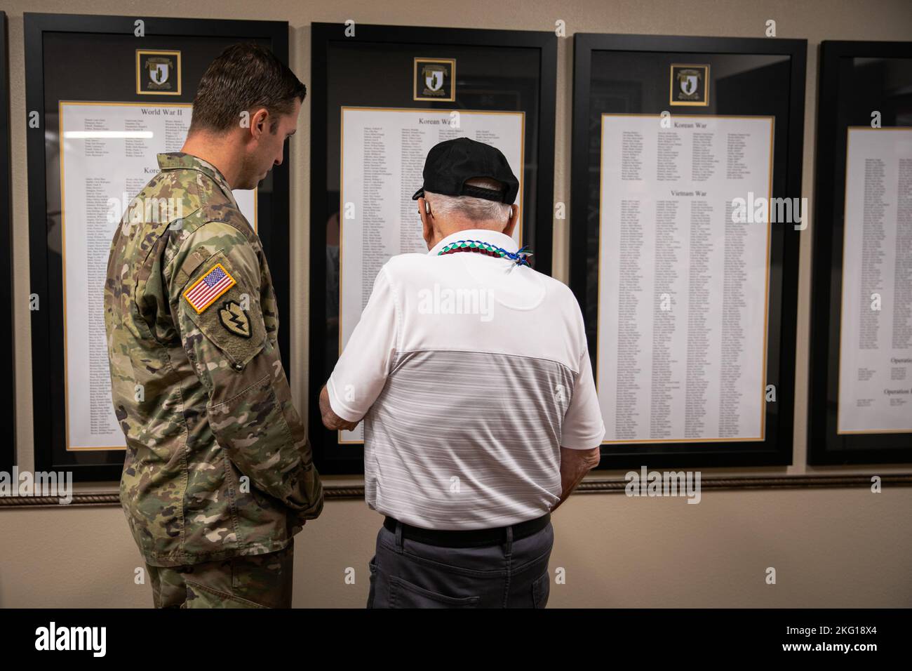 Private 2nd Class (ret.) Warren H. Schuster views a list of fallen ...