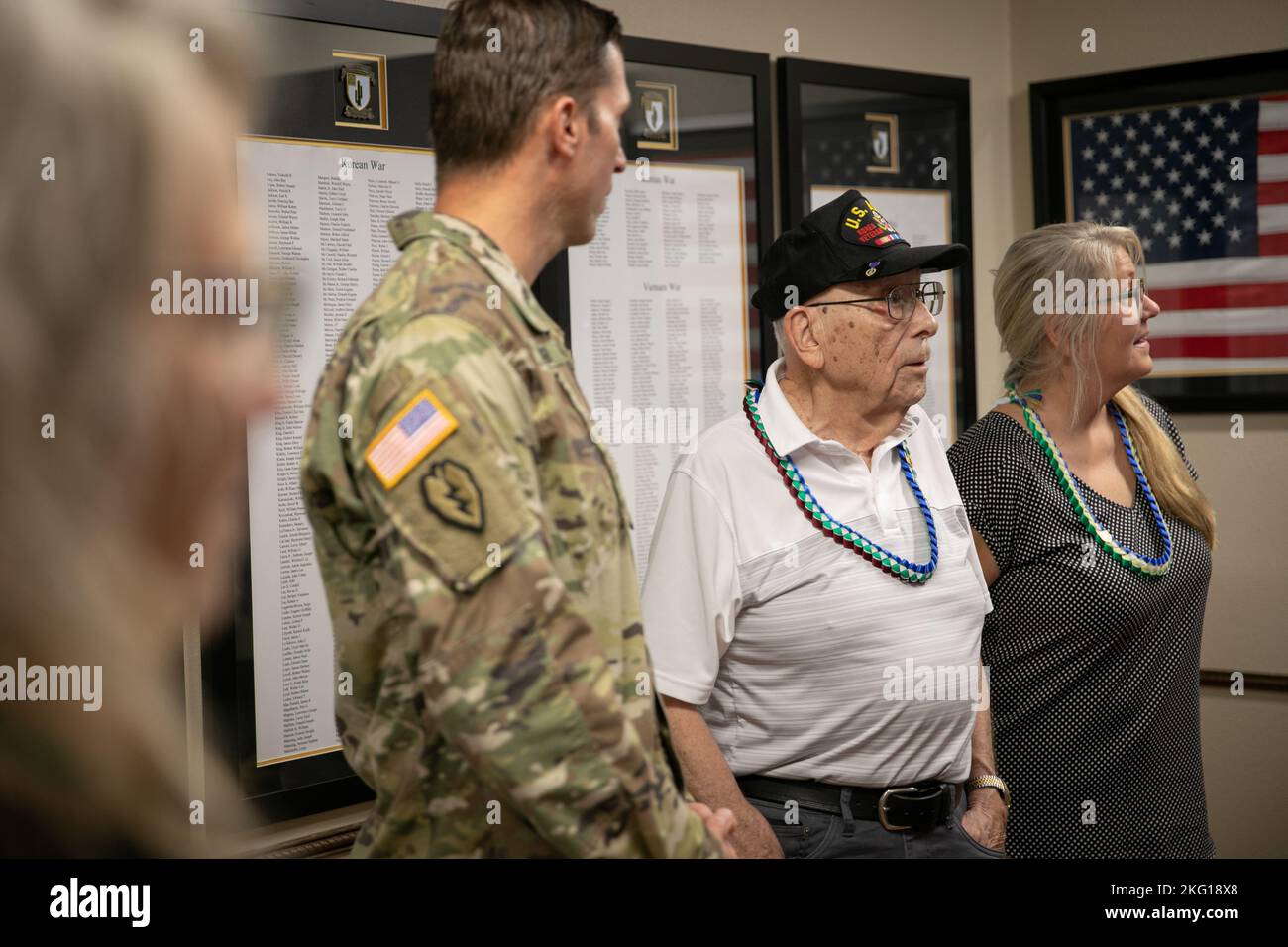 Private 2nd Class (ret.) Warren H. Schuster watches a memorial video ...