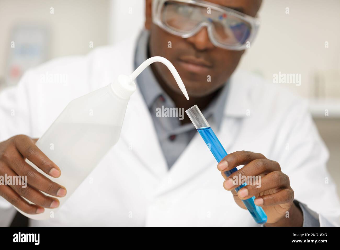 scientist in protective clothes working with toxic liquids in lab Stock ...