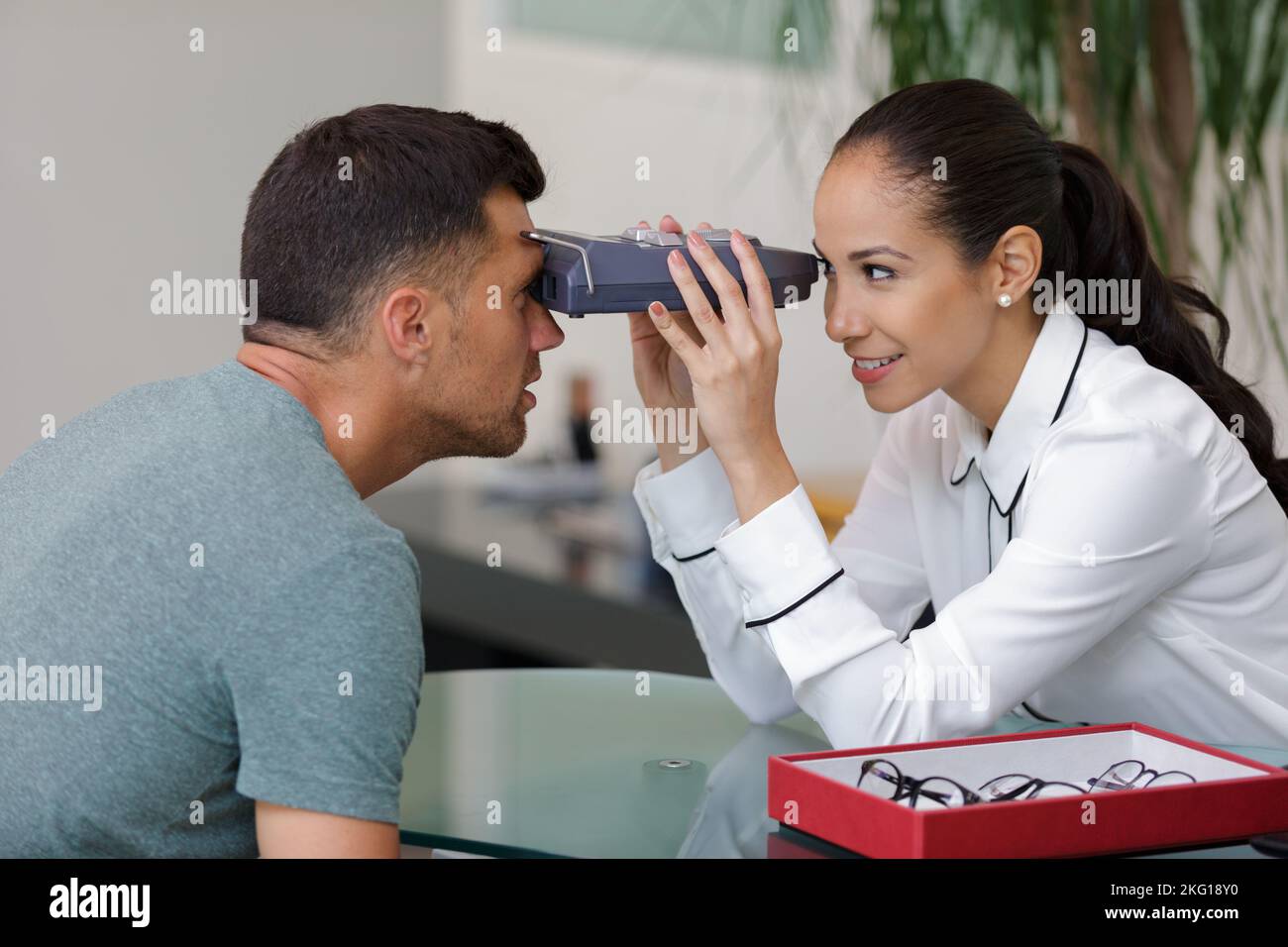 female optician checking eye sight Stock Photo - Alamy