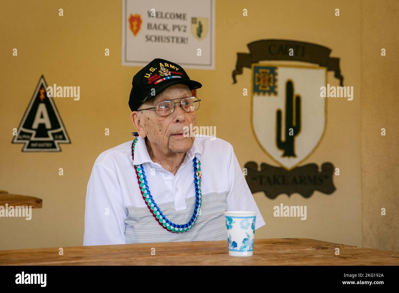 Private 2nd Class (ret.) Warren H. Schuster sits for refreshments ...