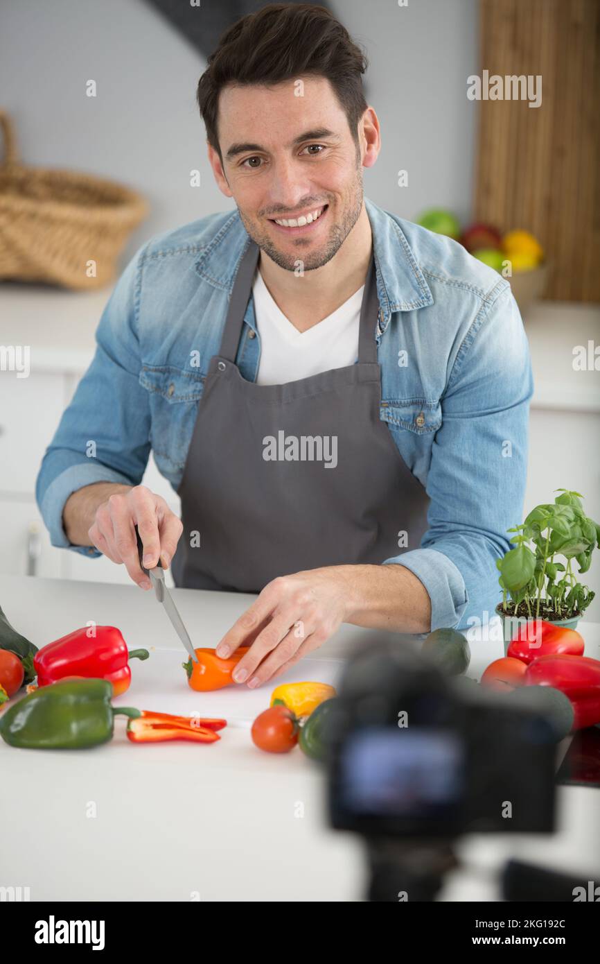 young man recording himself preparing food Stock Photo - Alamy