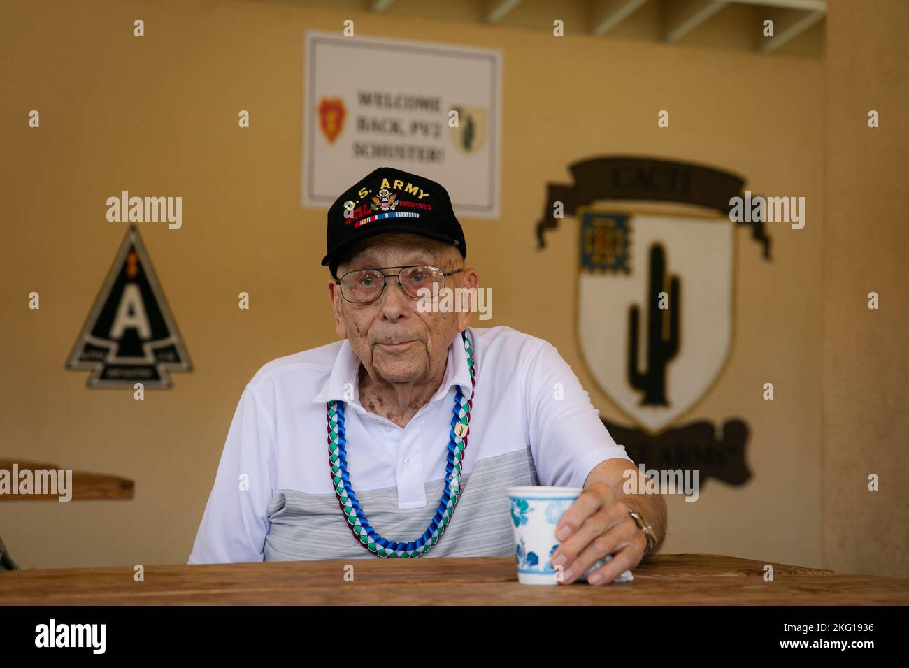 Private 2nd Class (ret.) Warren H. Schuster sits for refreshments after ...