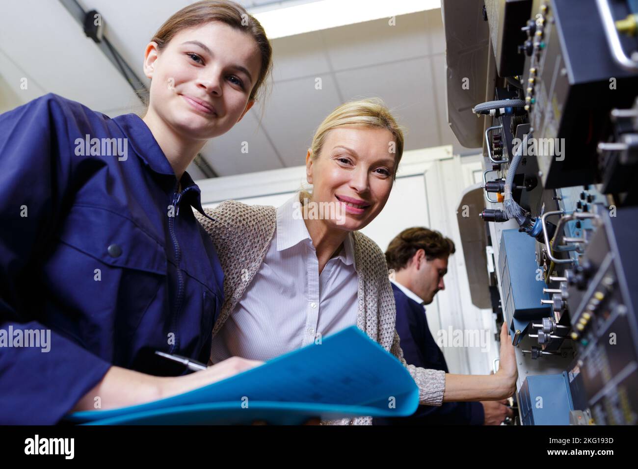 female aviation engineers posing and smiling Stock Photo - Alamy
