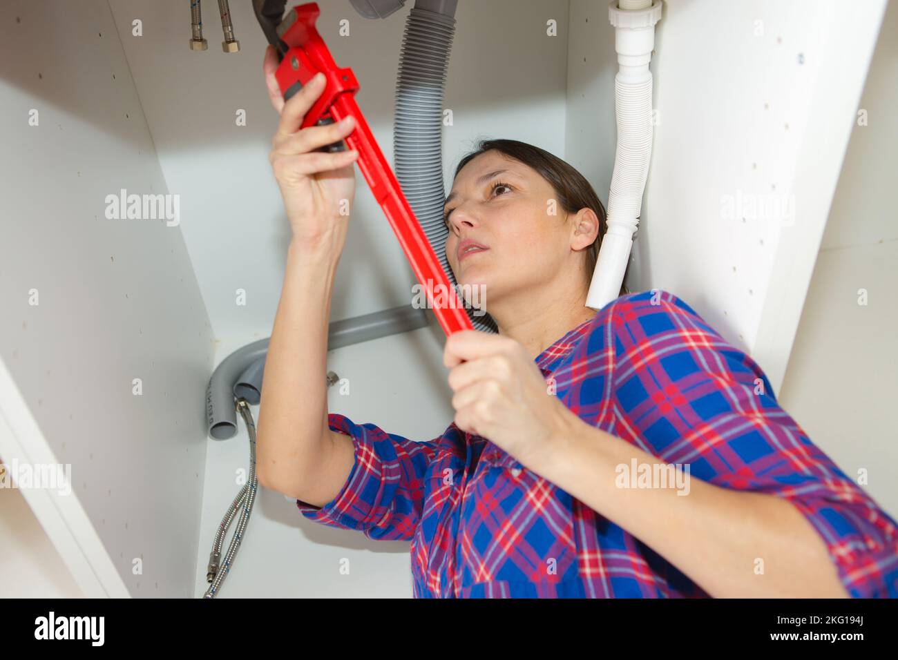 Female plumber under sink hi-res stock photography and images - Alamy