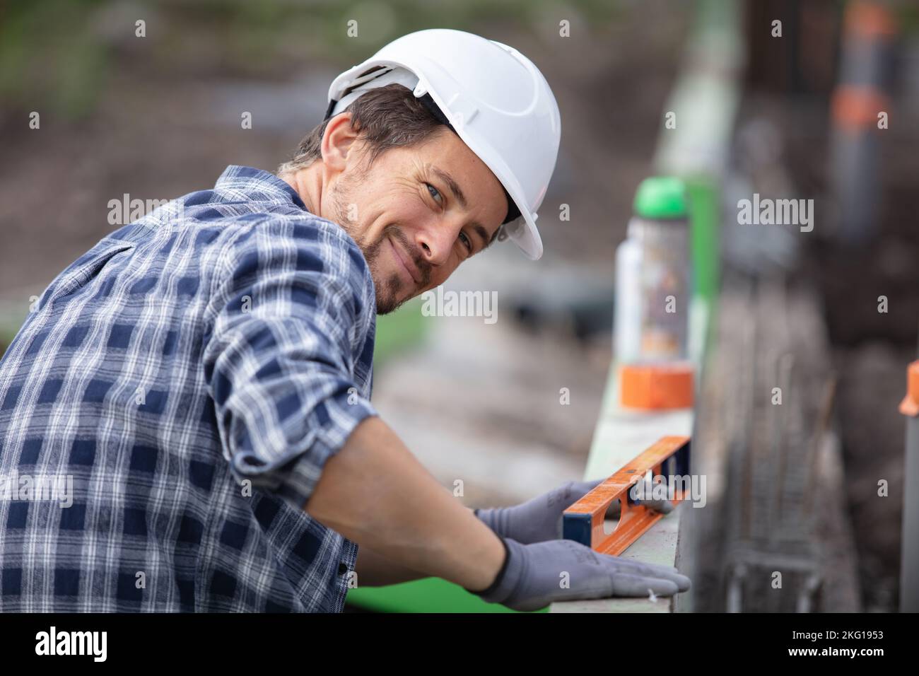 mason checking horizontal level of house Stock Photo - Alamy
