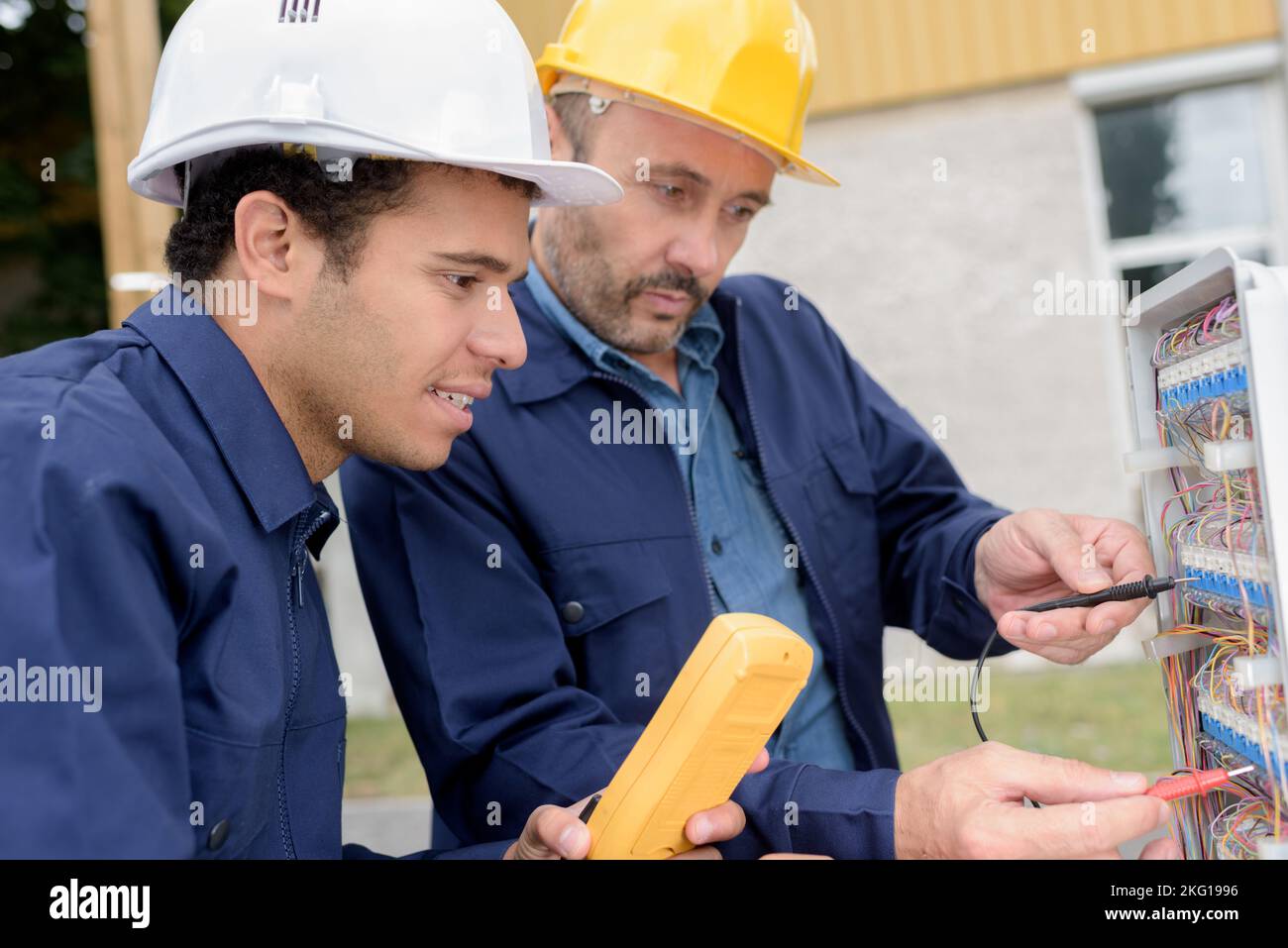 working electricians measure the voltage with a multimeter Stock Photo ...