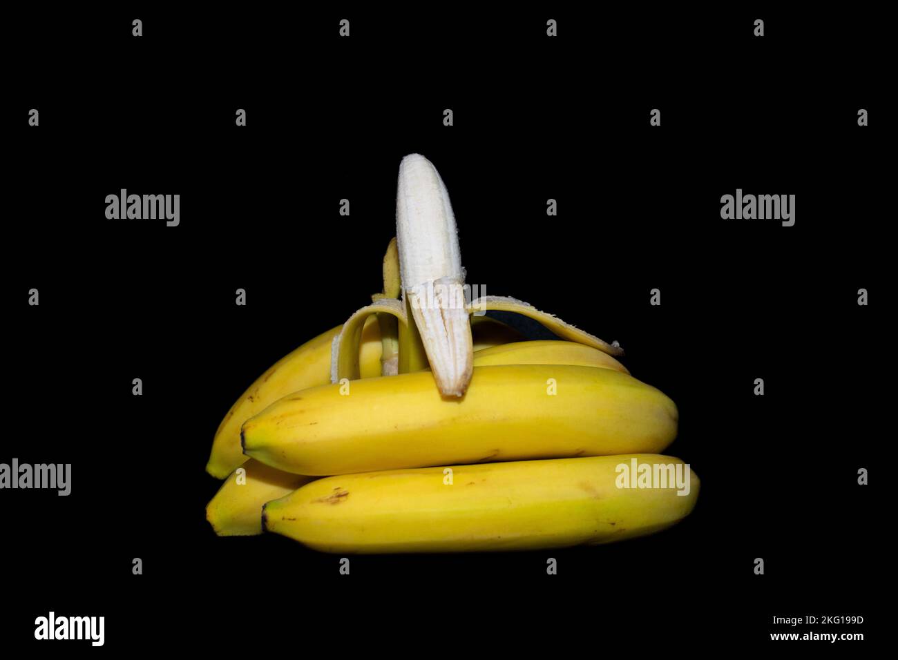 Yellow bananas on a black background Stock Photo - Alamy