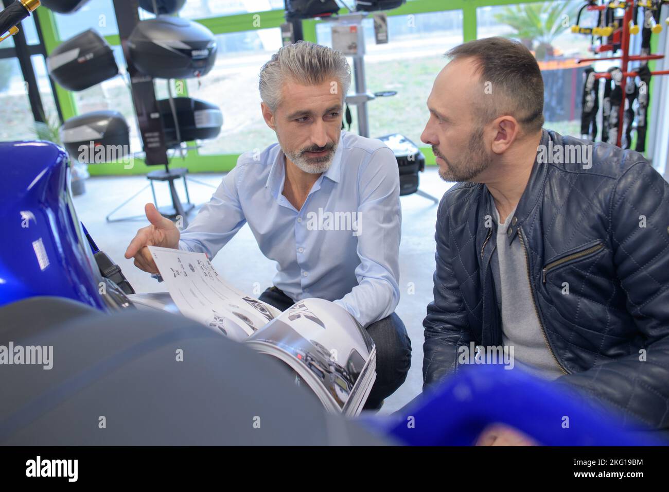 male customer talking to salon manager Stock Photo - Alamy