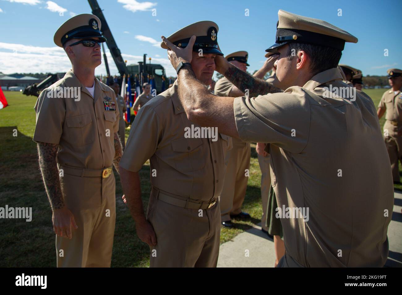 A newly promoted chief petty officer receives his new rank and cover ...