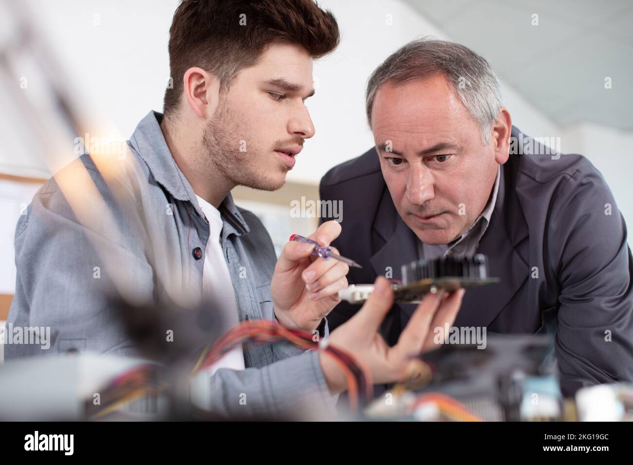 apprentice learning how to repair computer Stock Photo - Alamy